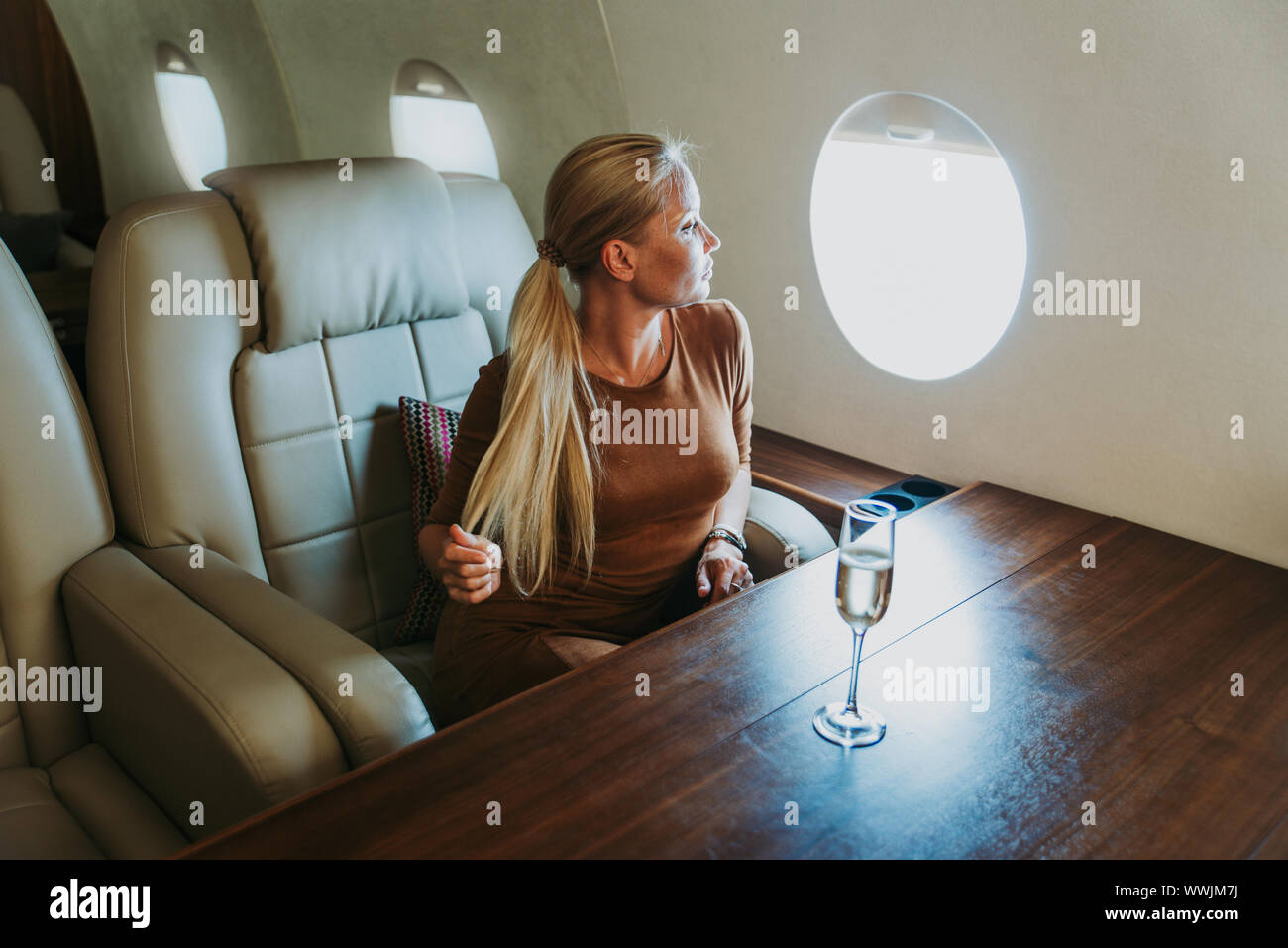 Beautiful woman traveling on her jet Stock Photo - Alamy