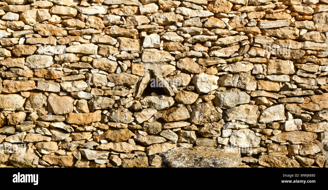 aged masonry stone wall triangle window hole Mediterranean Spain ...