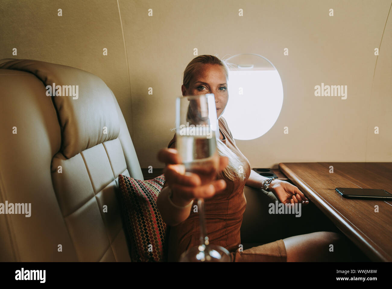 Beautiful woman traveling on her jet Stock Photo - Alamy