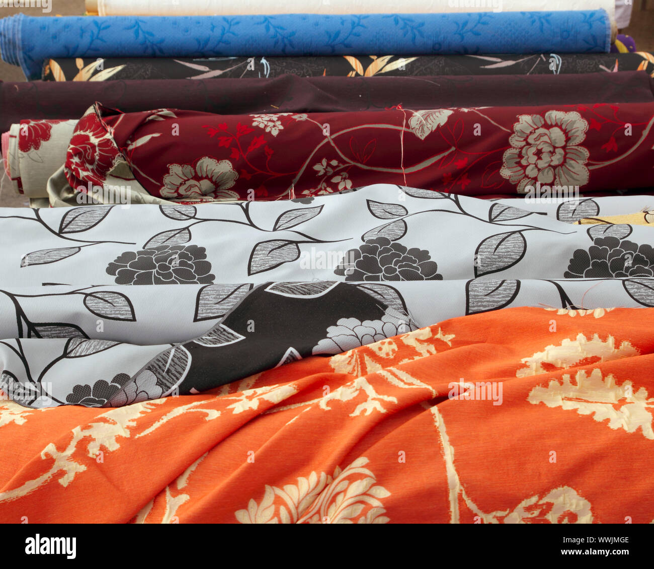 fashion fabric rolls in retail market shop pattern in a row Stock Photo ...