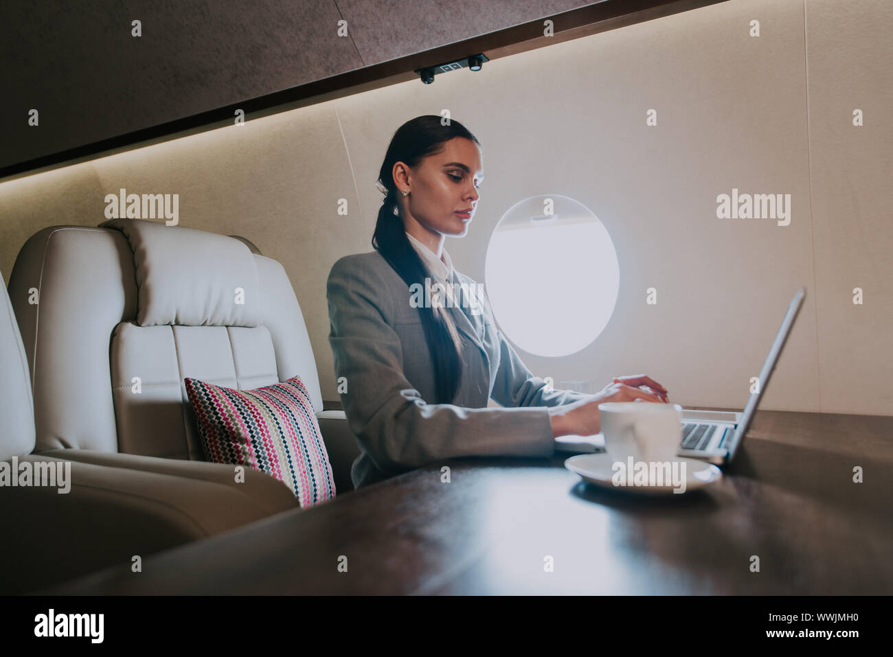 Business woman traveling and working on the private jet Stock Photo - Alamy