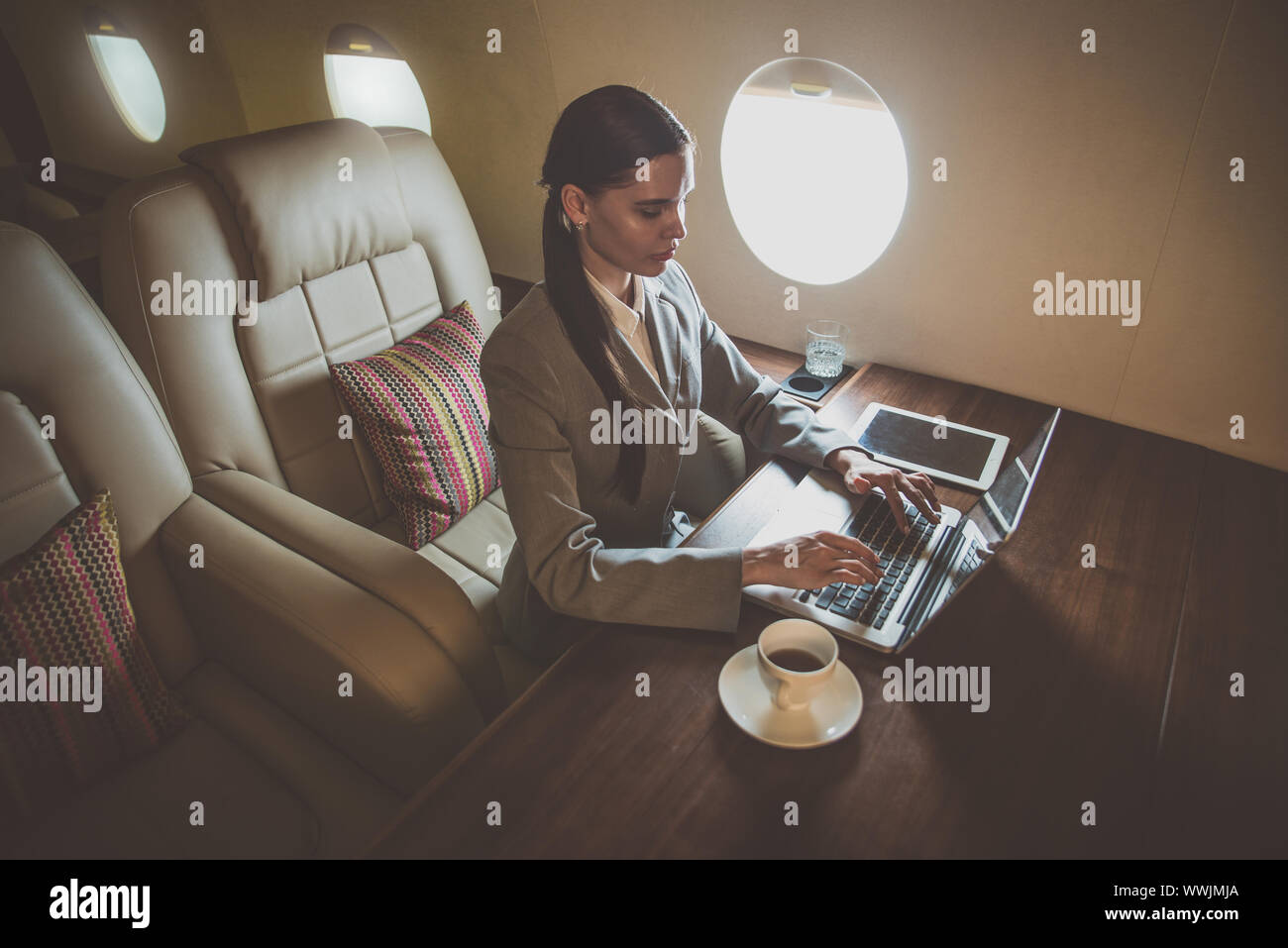 Business woman traveling and working on the private jet Stock Photo - Alamy