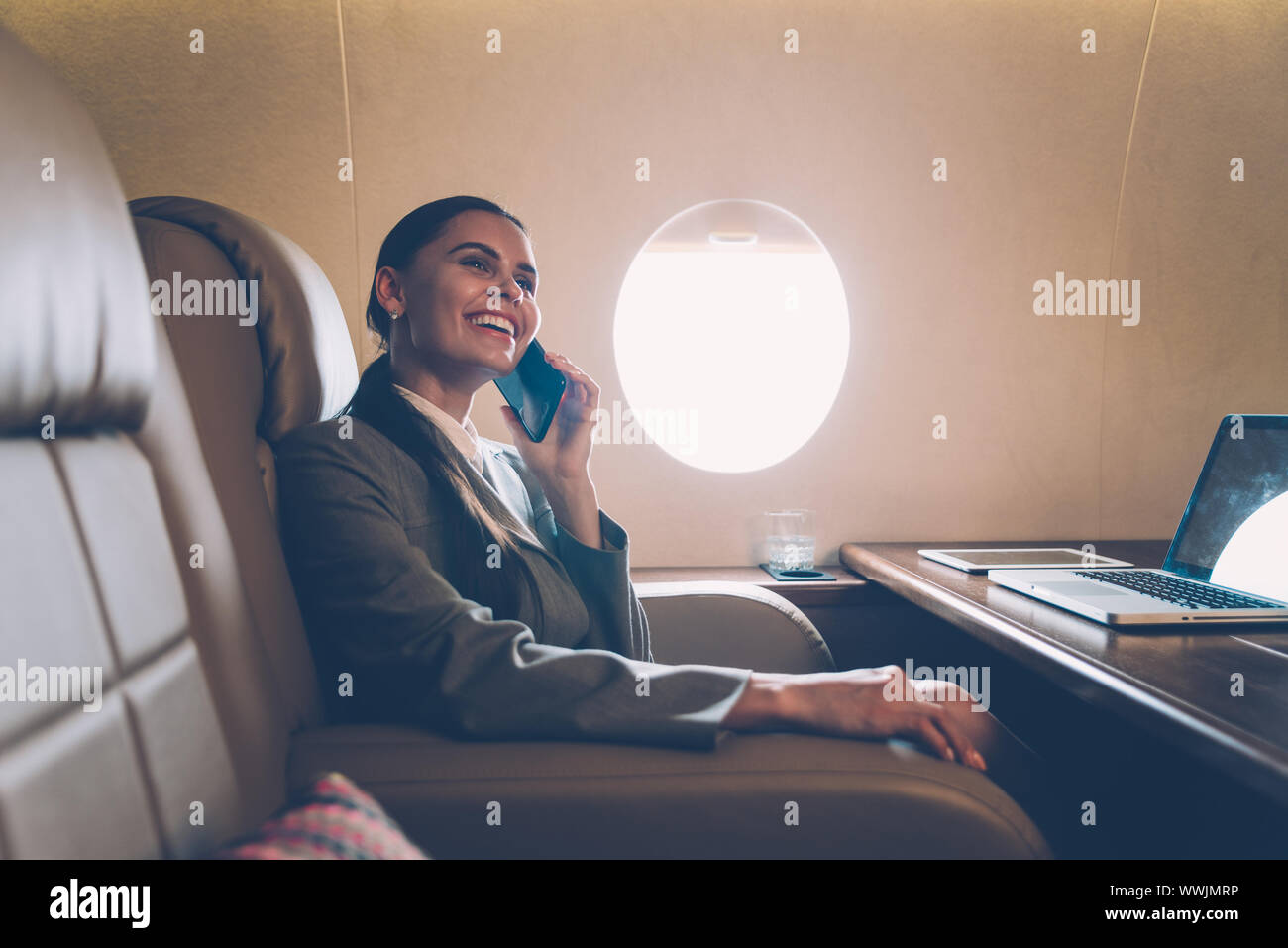 Business woman traveling and working on the private jet Stock Photo - Alamy
