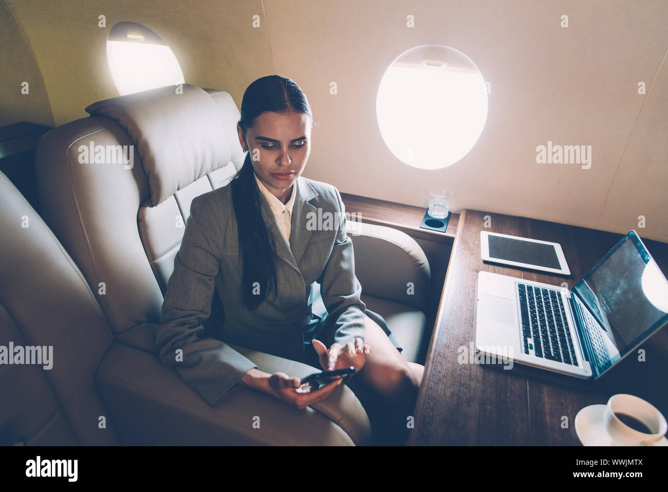 Business woman traveling and working on the private jet Stock Photo - Alamy