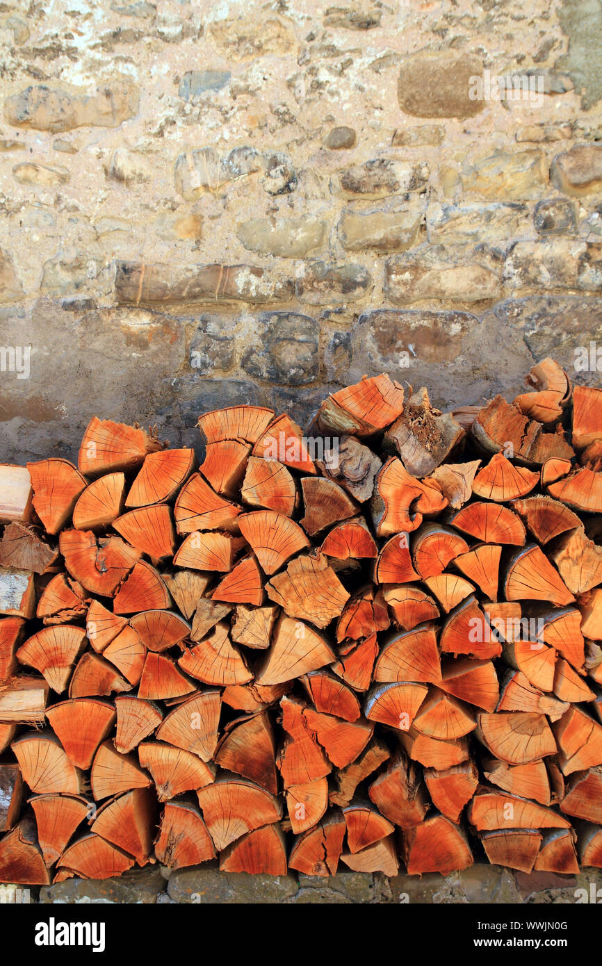 firewood wood pile stacked triangle shape red color Stock Photo - Alamy