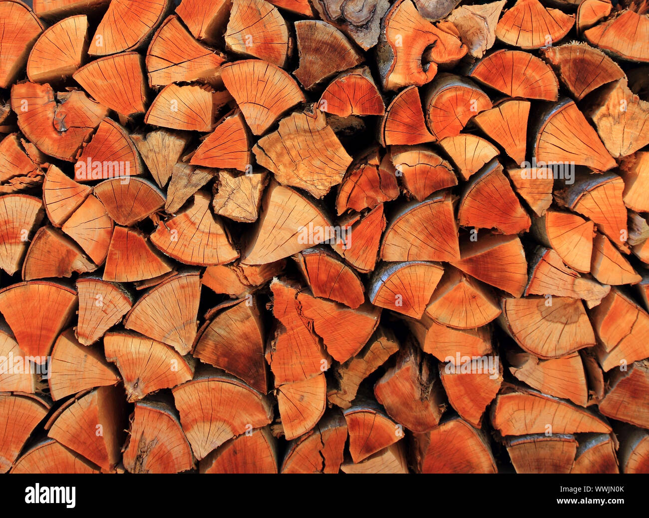 firewood wood pile stacked triangle shape red color Stock Photo - Alamy
