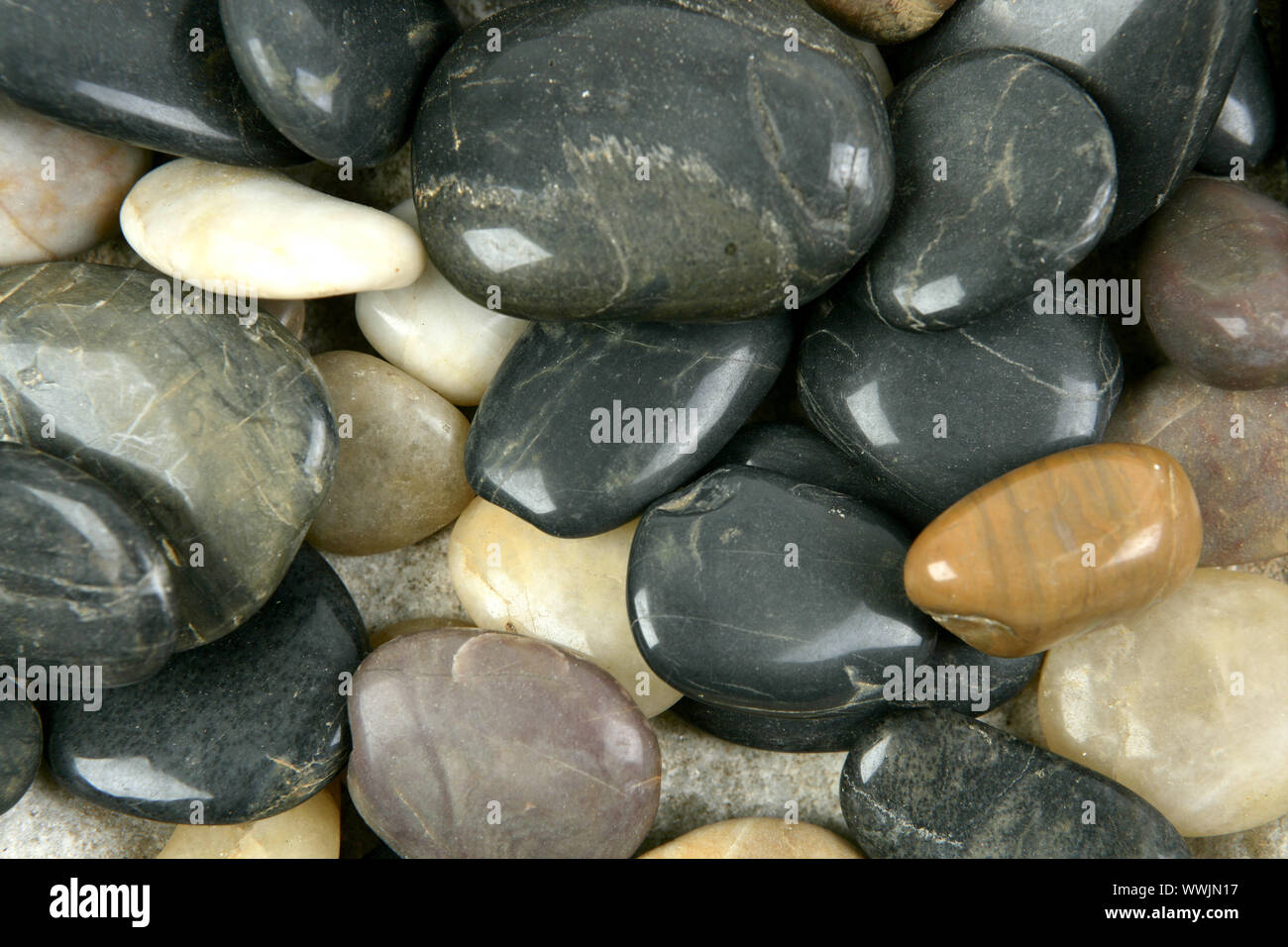 Rolling dark stones shiny texture pattern background Stock Photo - Alamy