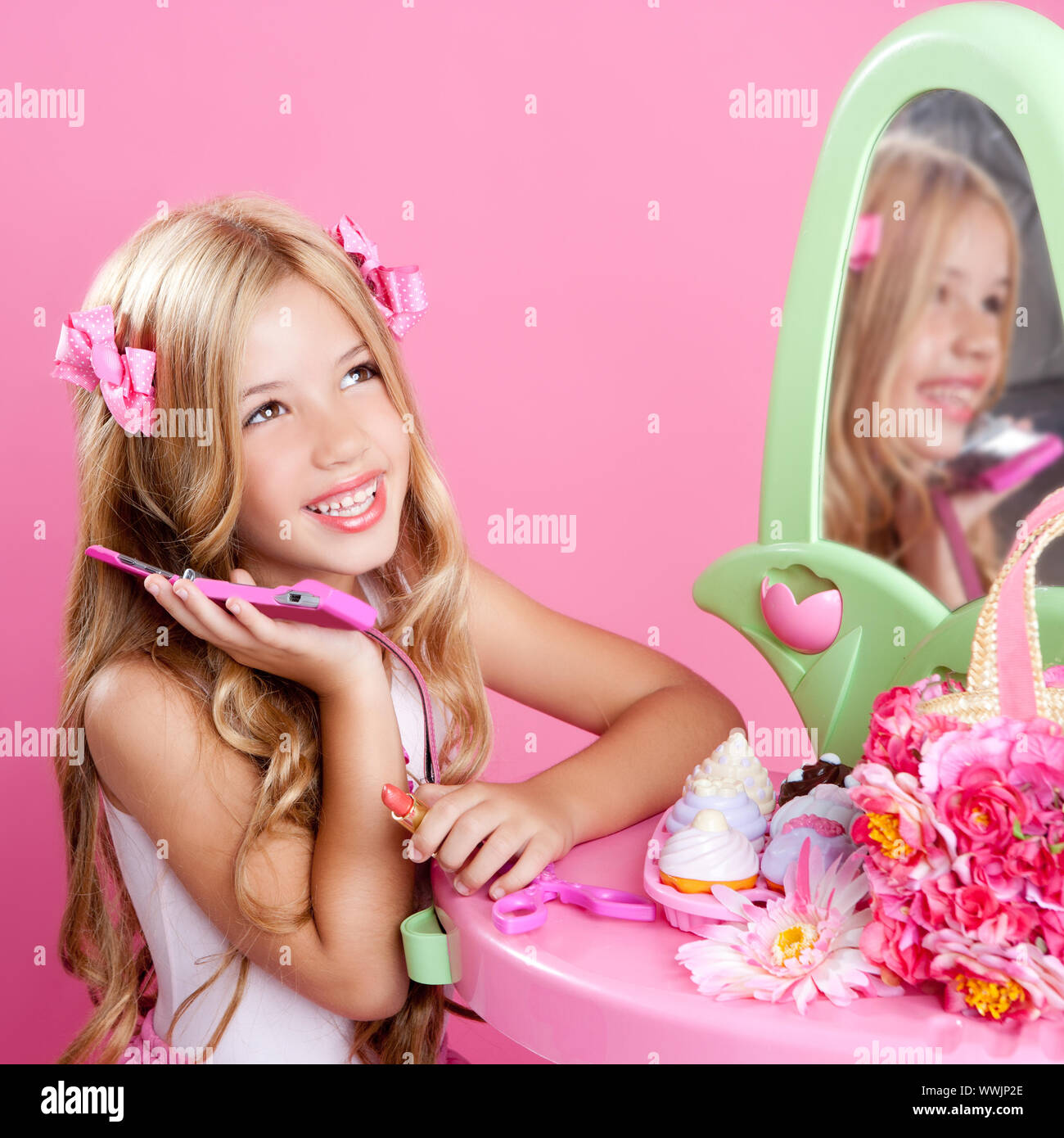 blond fashion doll girl talking with mobile phone in pink vanity Stock ...