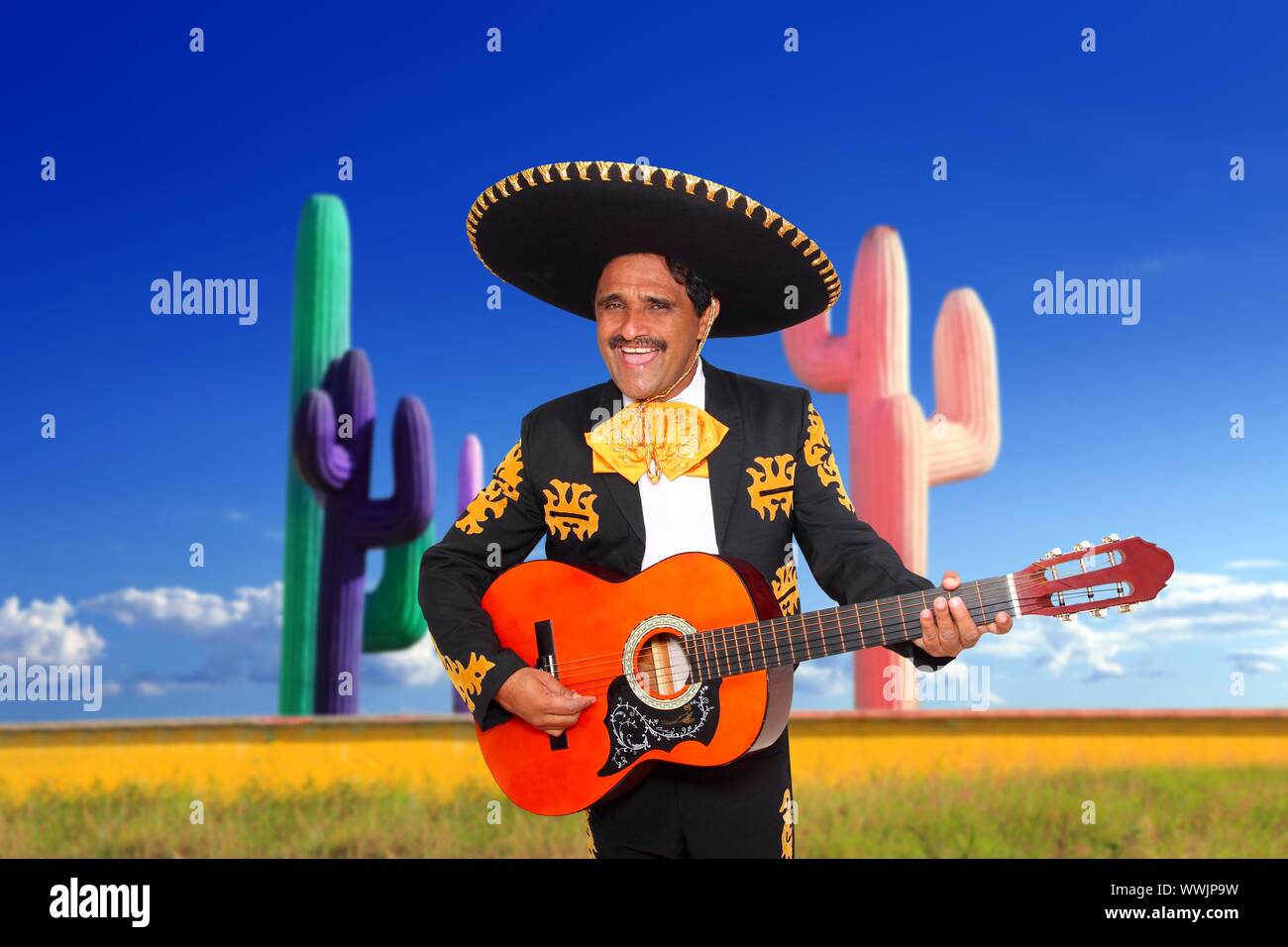 Mexican mariachi charro singing playing guitar in cactus background ...