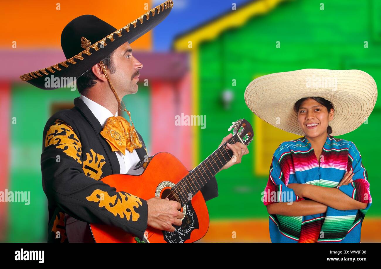 Mexican mariachi charro man singing a song to a poncho Mexico girl ...