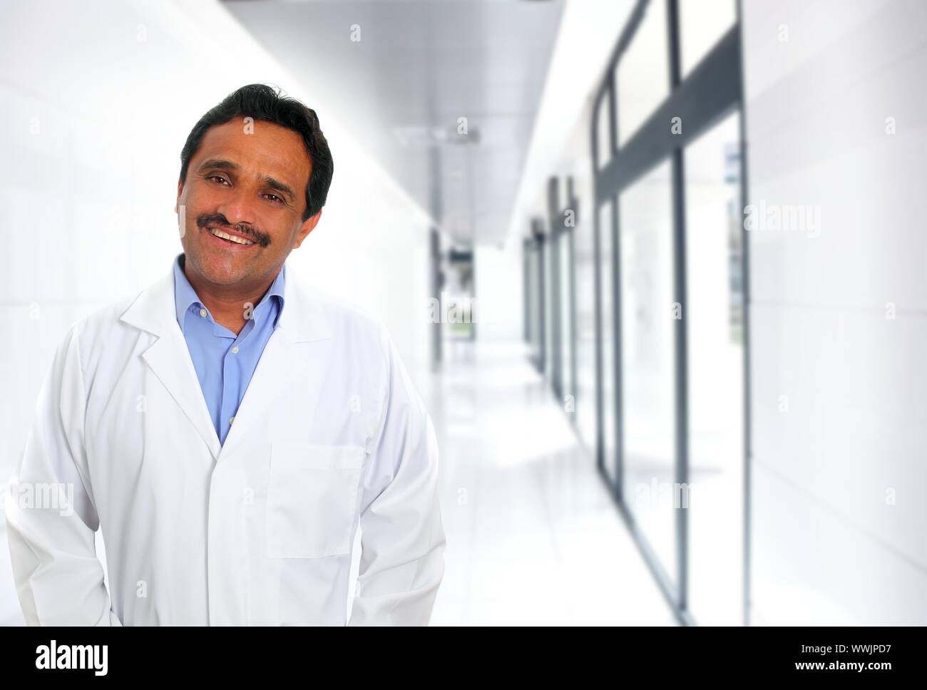 Indian latin doctor expertise smiling in hospital corridor Stock Photo ...