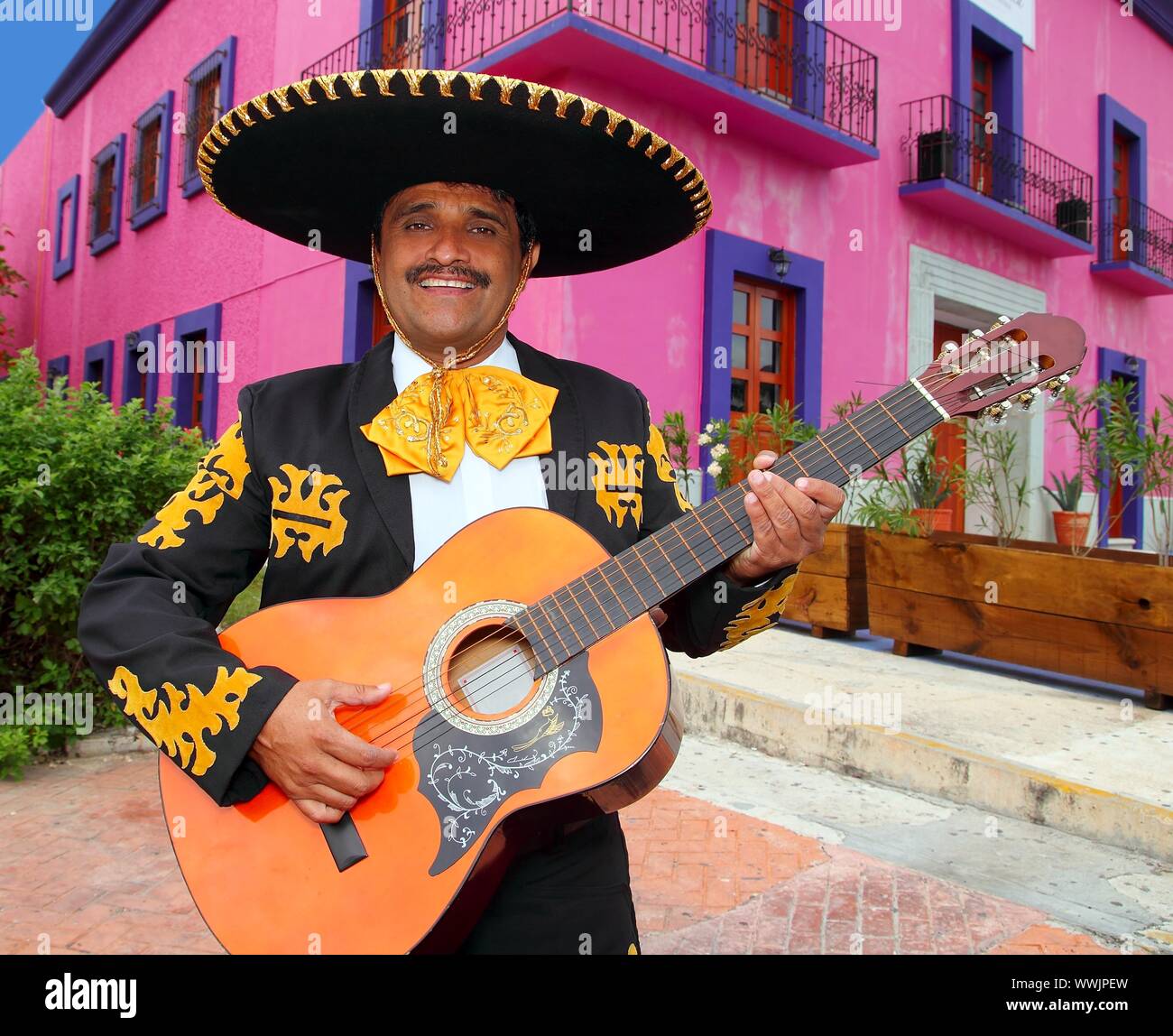 Charro Mariachi singer playing guitar in Mexico houses background Stock ...