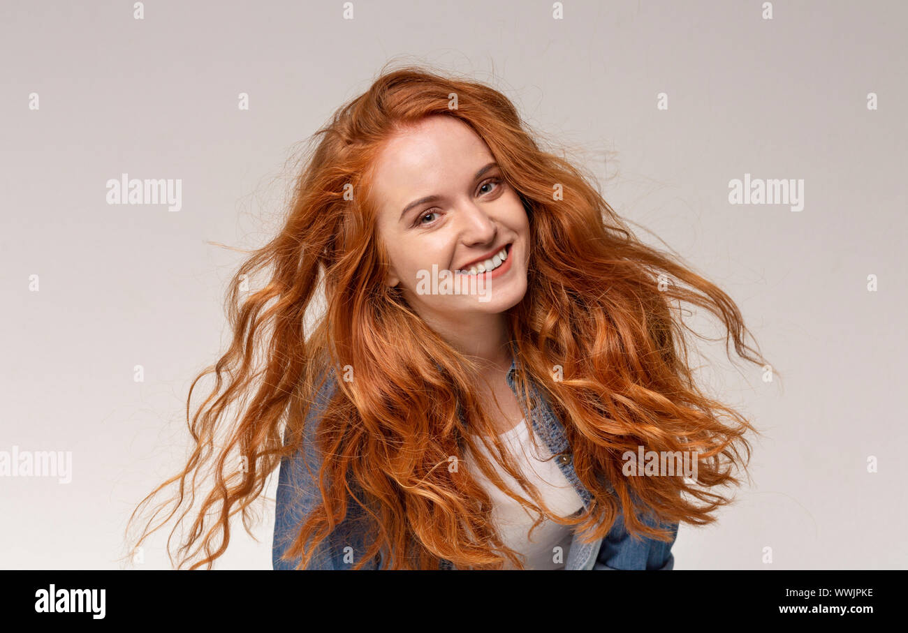 Young girl with long beautiful ginger hair smiling to camera Stock ...
