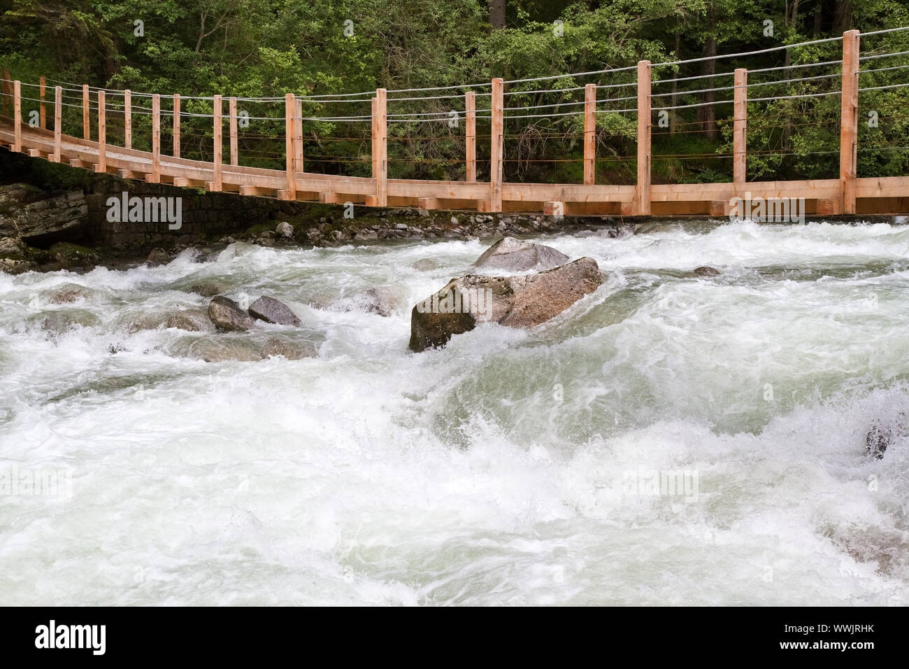 Wooden bridge over a torrent Stock Photo - Alamy