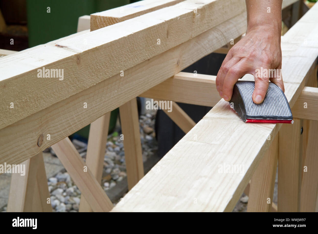 Sanding wooden beams by hand Stock Photo - Alamy