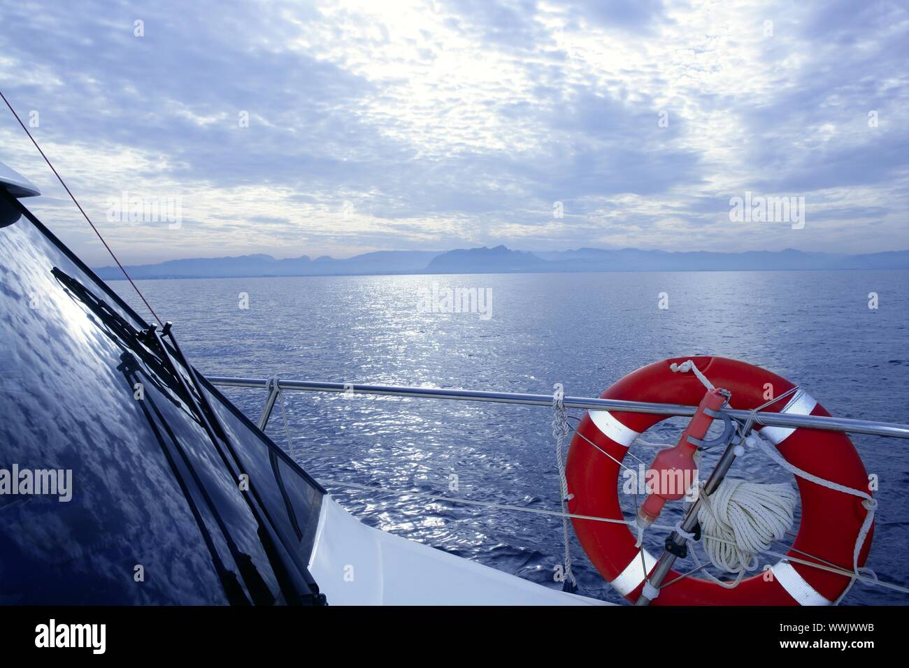 Boat rail with round orange lifesaver and blue sunset sea ocean Stock ...