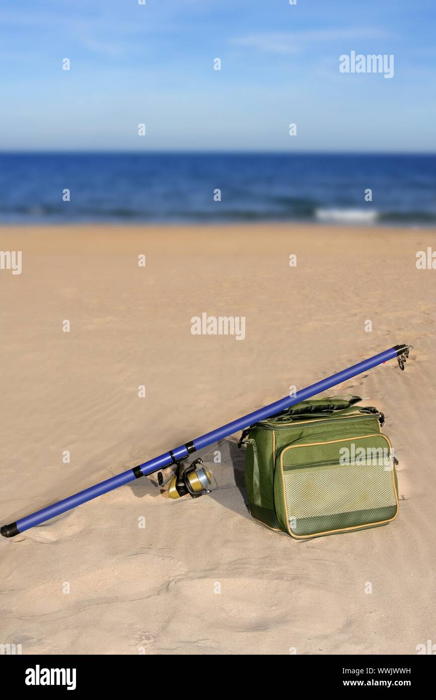 Fishing surfcasting rod and box over beach sand sea background Stock ...