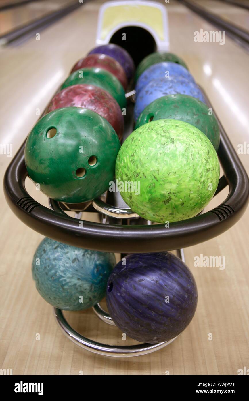 Bowling balls perspective in game center wooden floor Stock Photo - Alamy