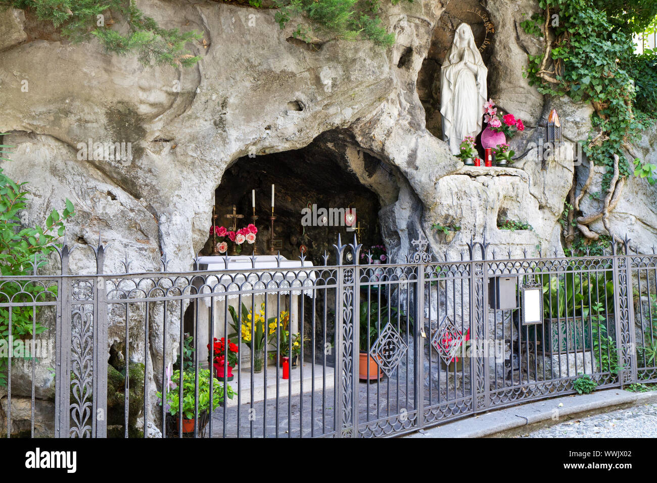 Wayside shrine with rock grotto in Italy Stock Photo - Alamy