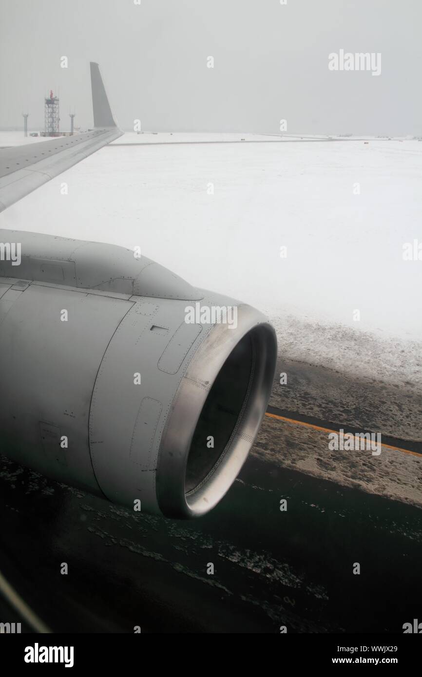 aircraft wing with turbine landing on winter snow runway Stock Photo ...