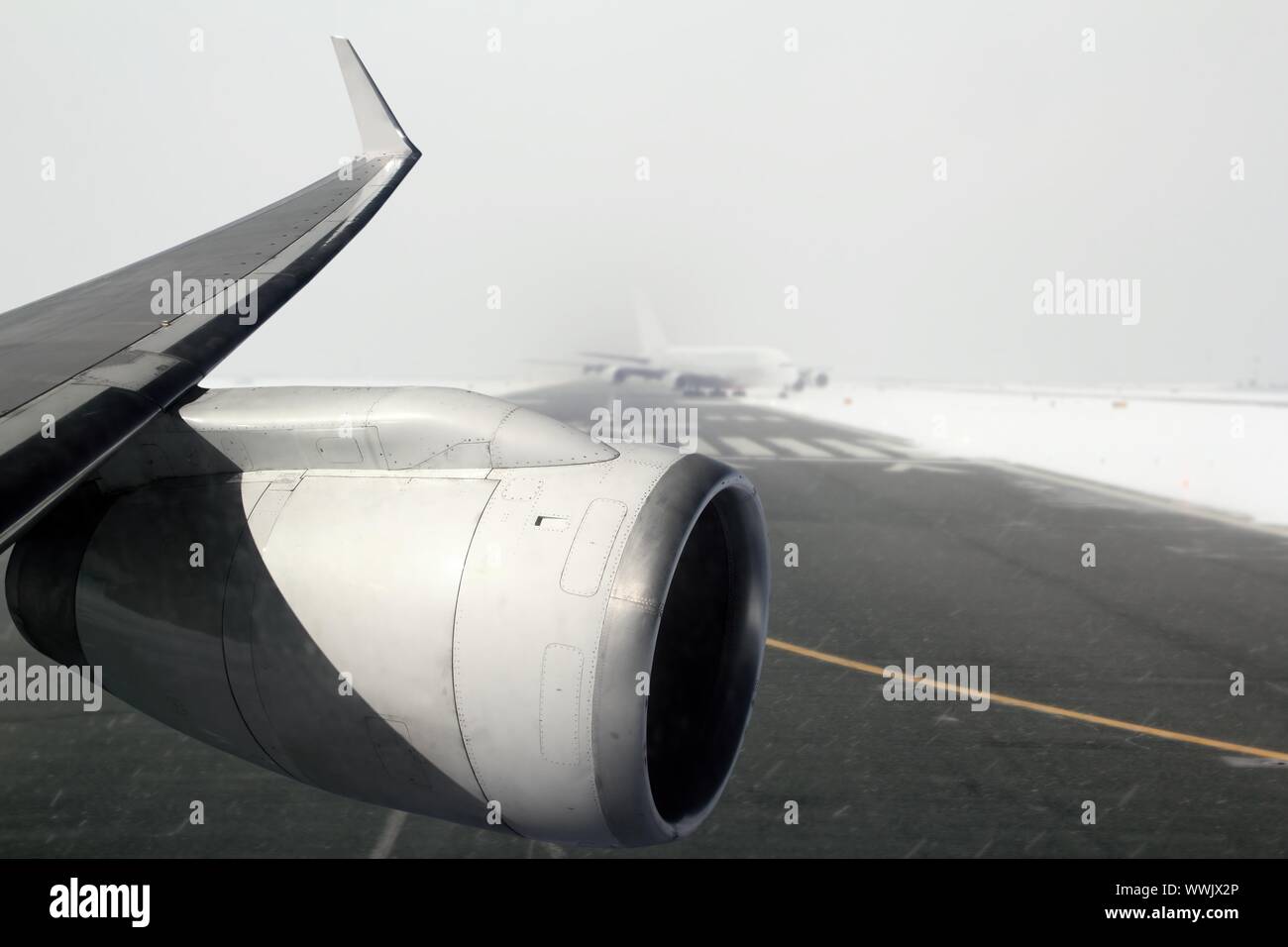 aircraft wing with turbine landing on snow winter runway Stock Photo ...