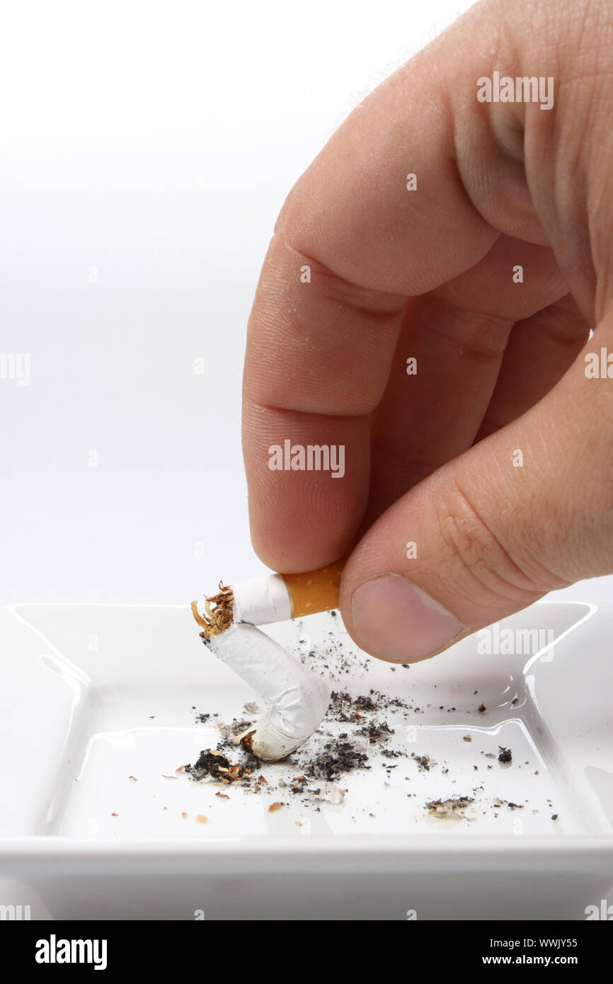 Hand stubbing out a cigarette on white ashtray isolated on white Stock ...