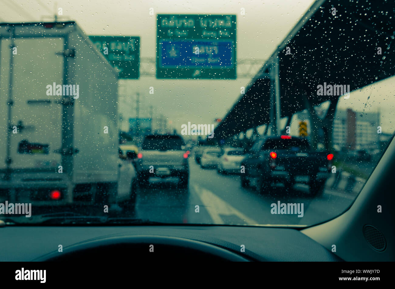 car window with rain drops driving in rain.Traffic jam background ...