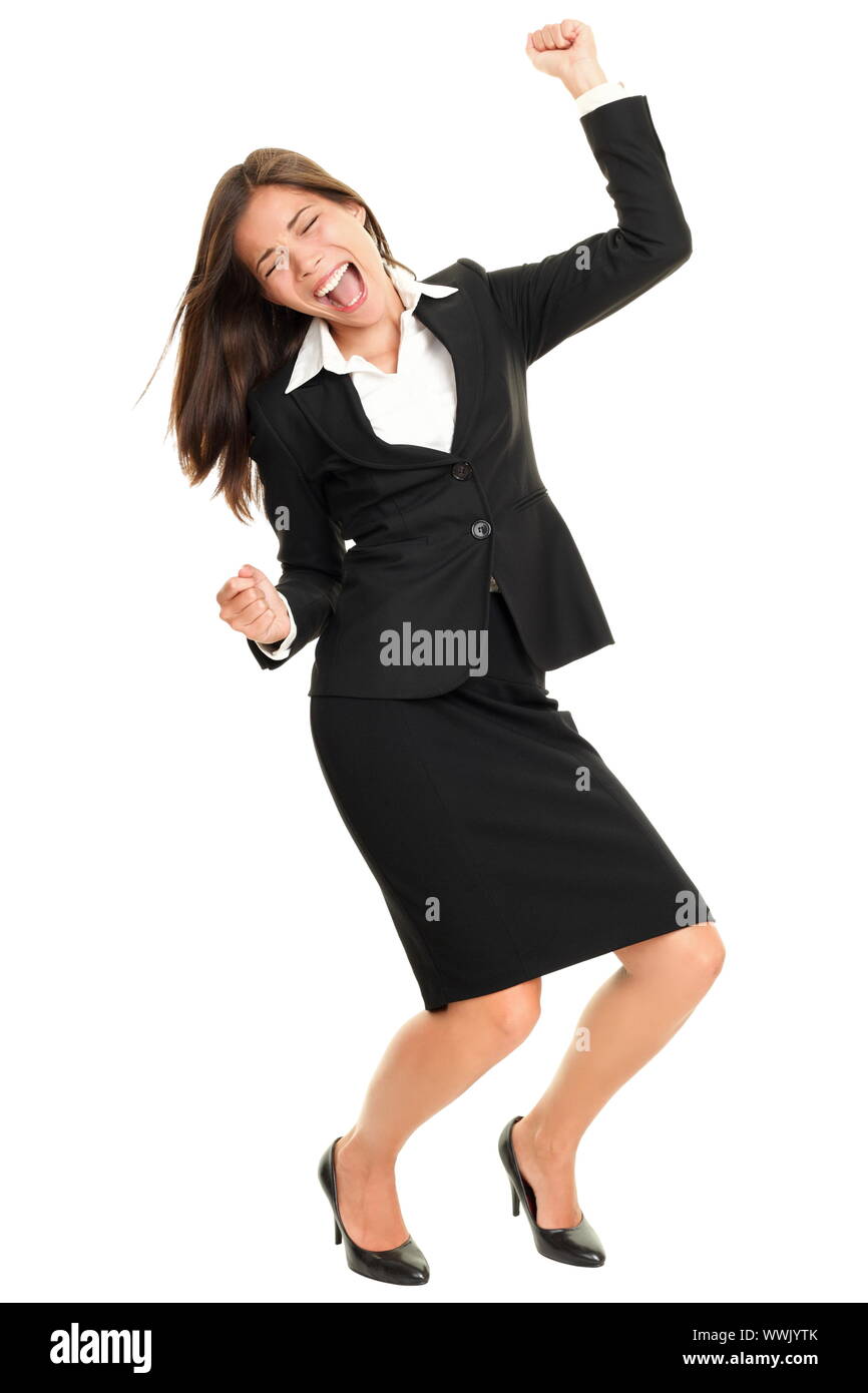 Celebrating business woman dancing happy and joyful cheering in suit ...