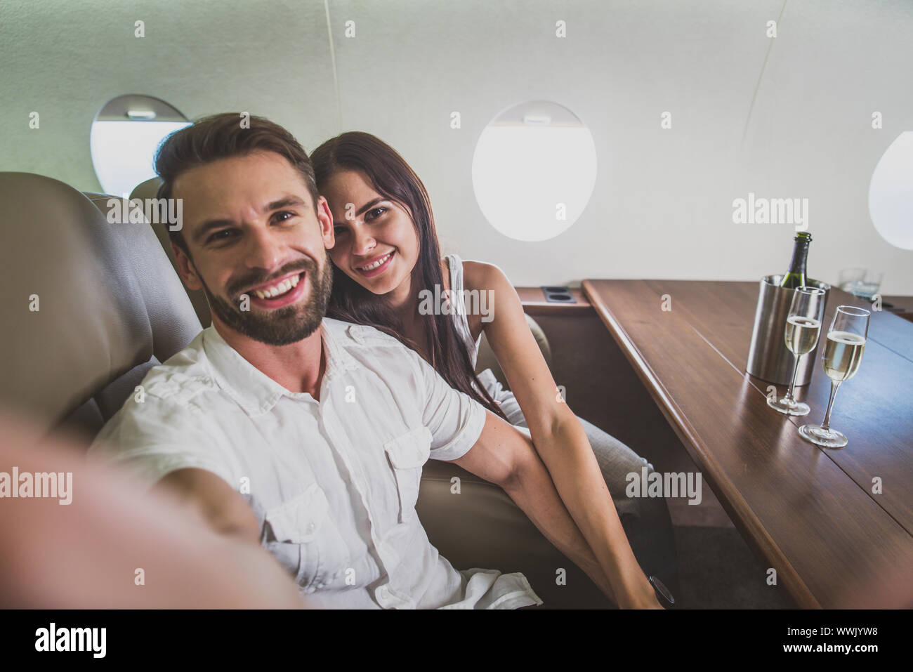 Couple on vacation, flying on their private jet Stock Photo - Alamy