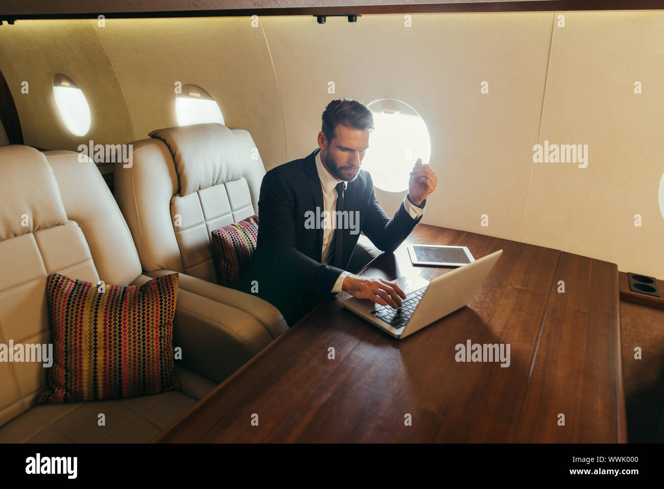 Businessman flying on his private jet Stock Photo - Alamy