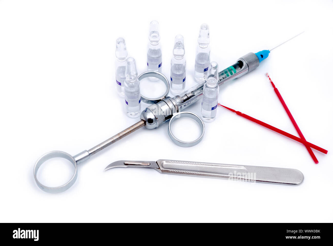 Medical instruments: a syringe, a scalpel and ampoules Stock Photo - Alamy