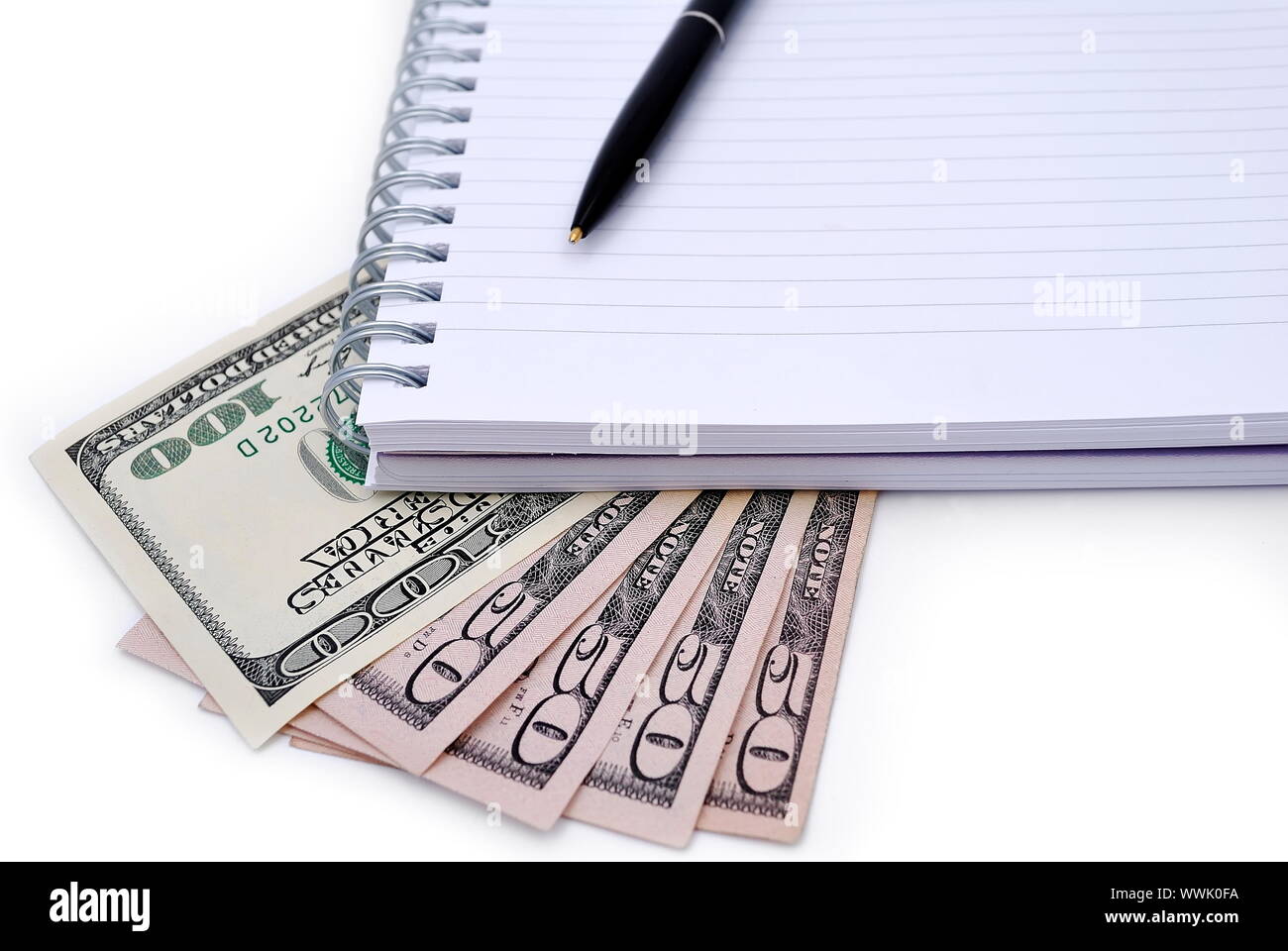 Pen, Notebook and some dollars banknotes isolated on white background ...