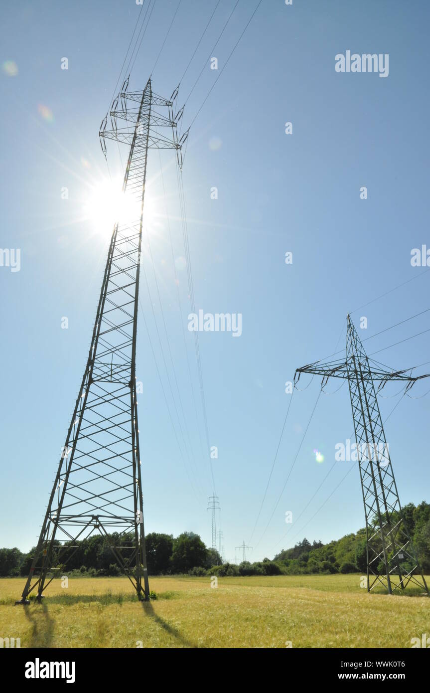 High voltage pylon and sun Stock Photo - Alamy