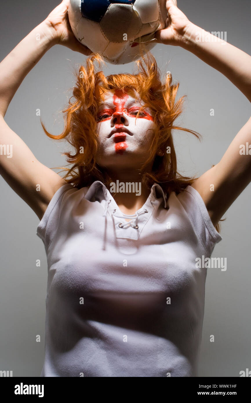 english football makeup girl holding worn soccer ball, looking proudly ...