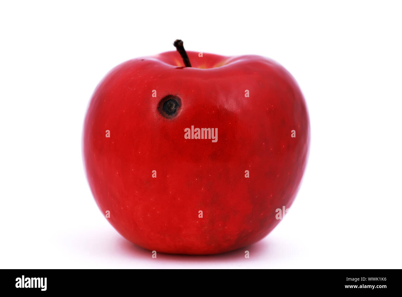 red apple with a ruffled hole on a white background Stock Photo - Alamy