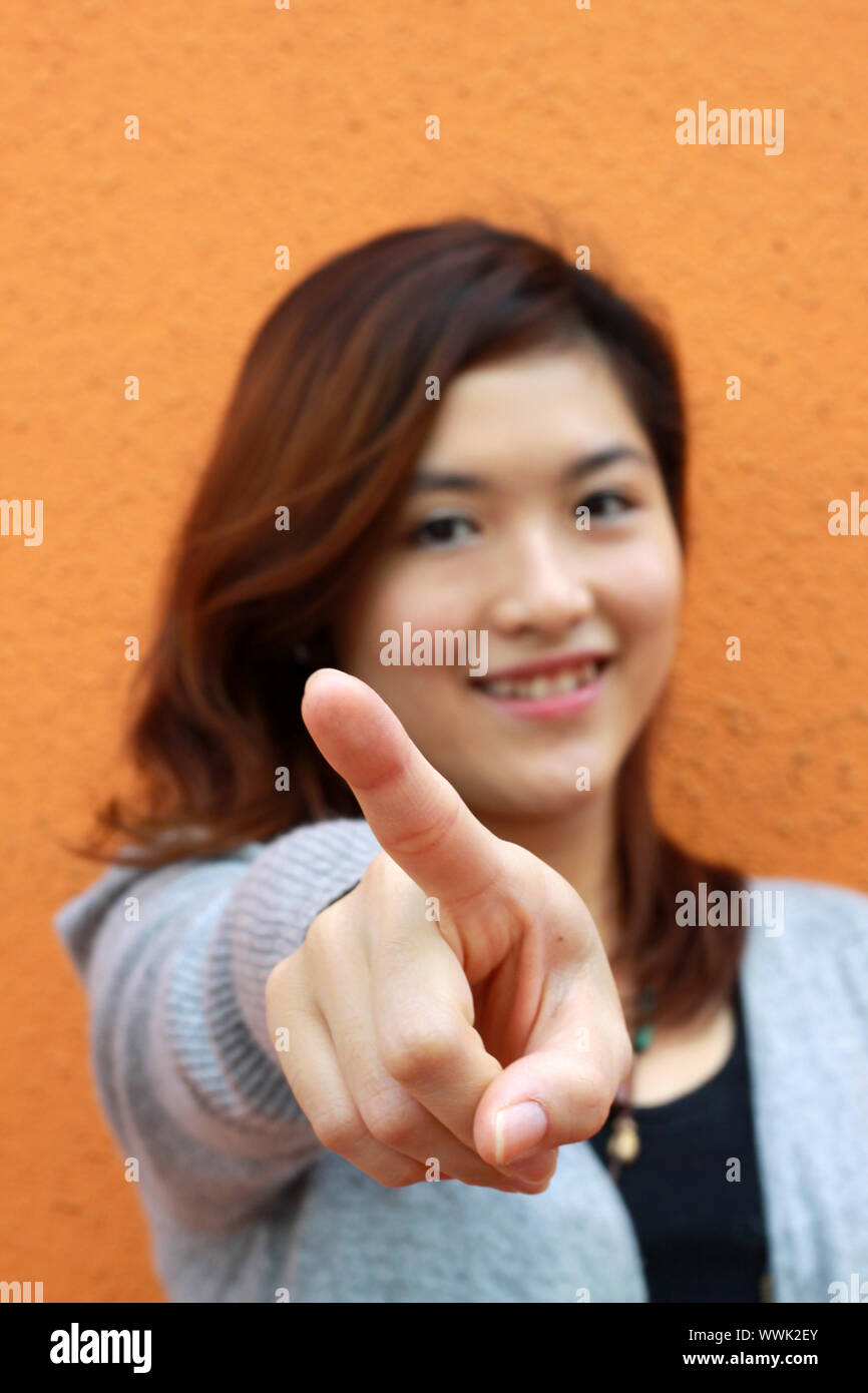 Asian woman pointing Stock Photo - Alamy