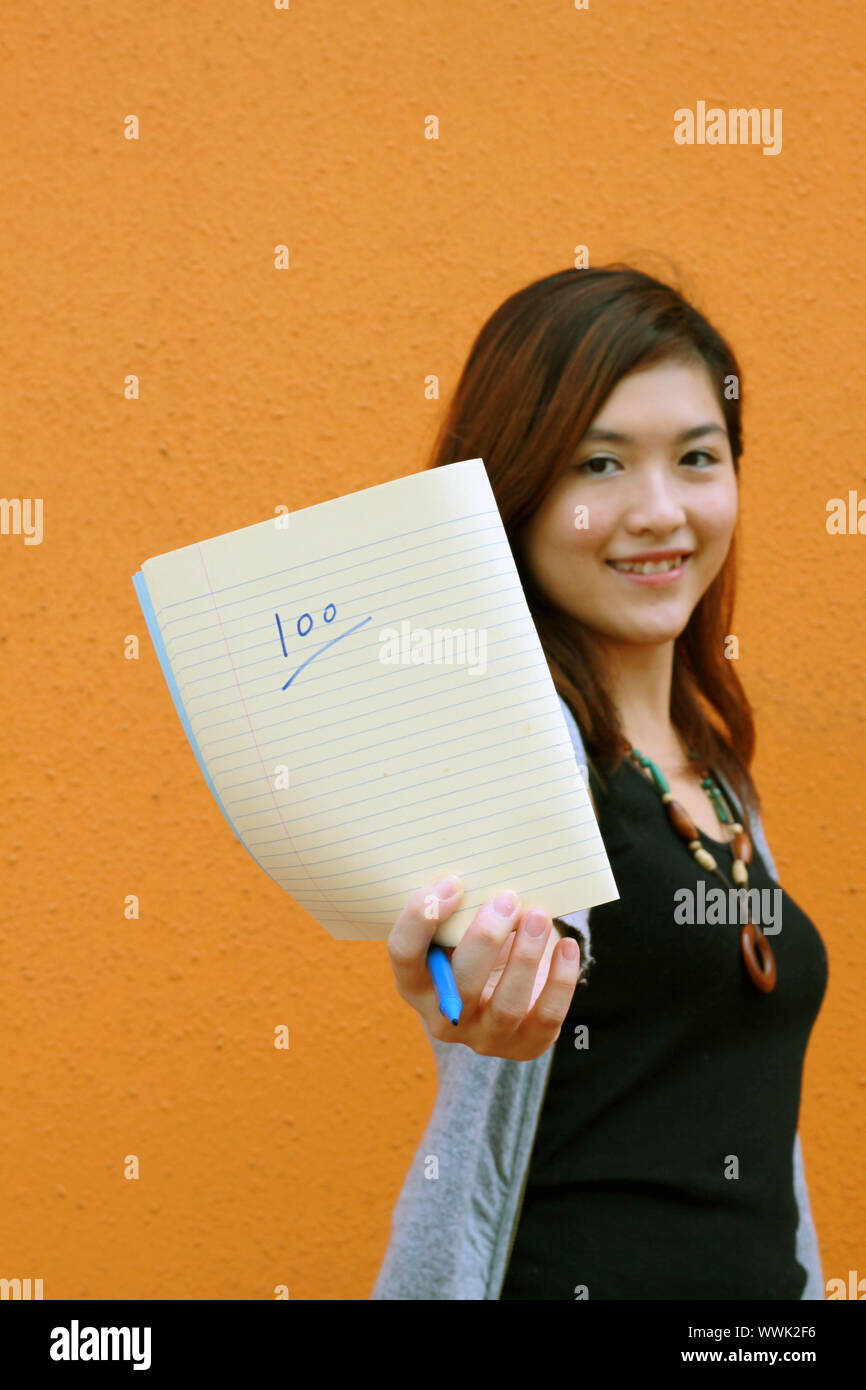 Asian university student showing full marks Stock Photo - Alamy