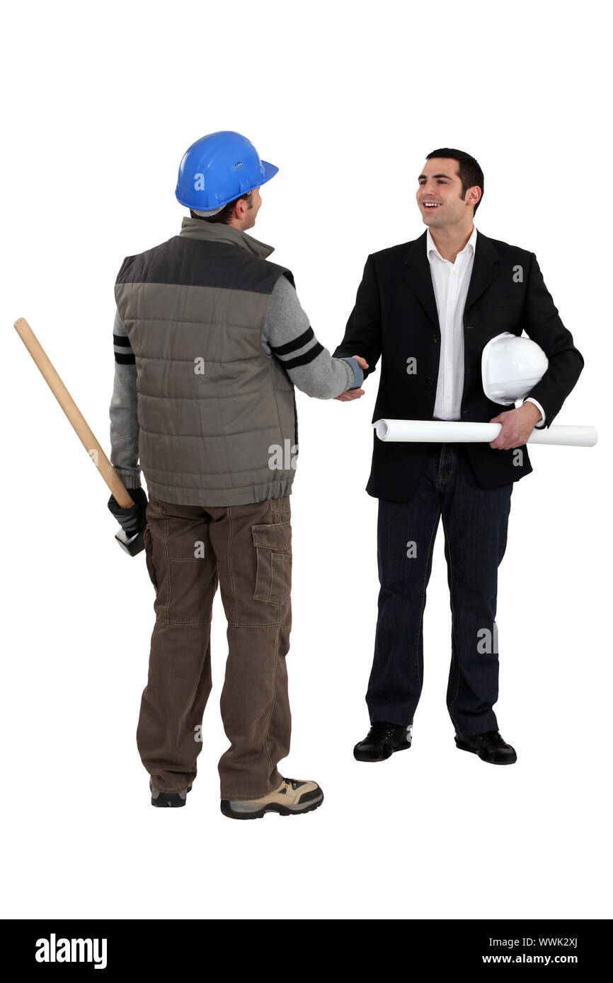 Architect shaking laborer's hand Stock Photo - Alamy