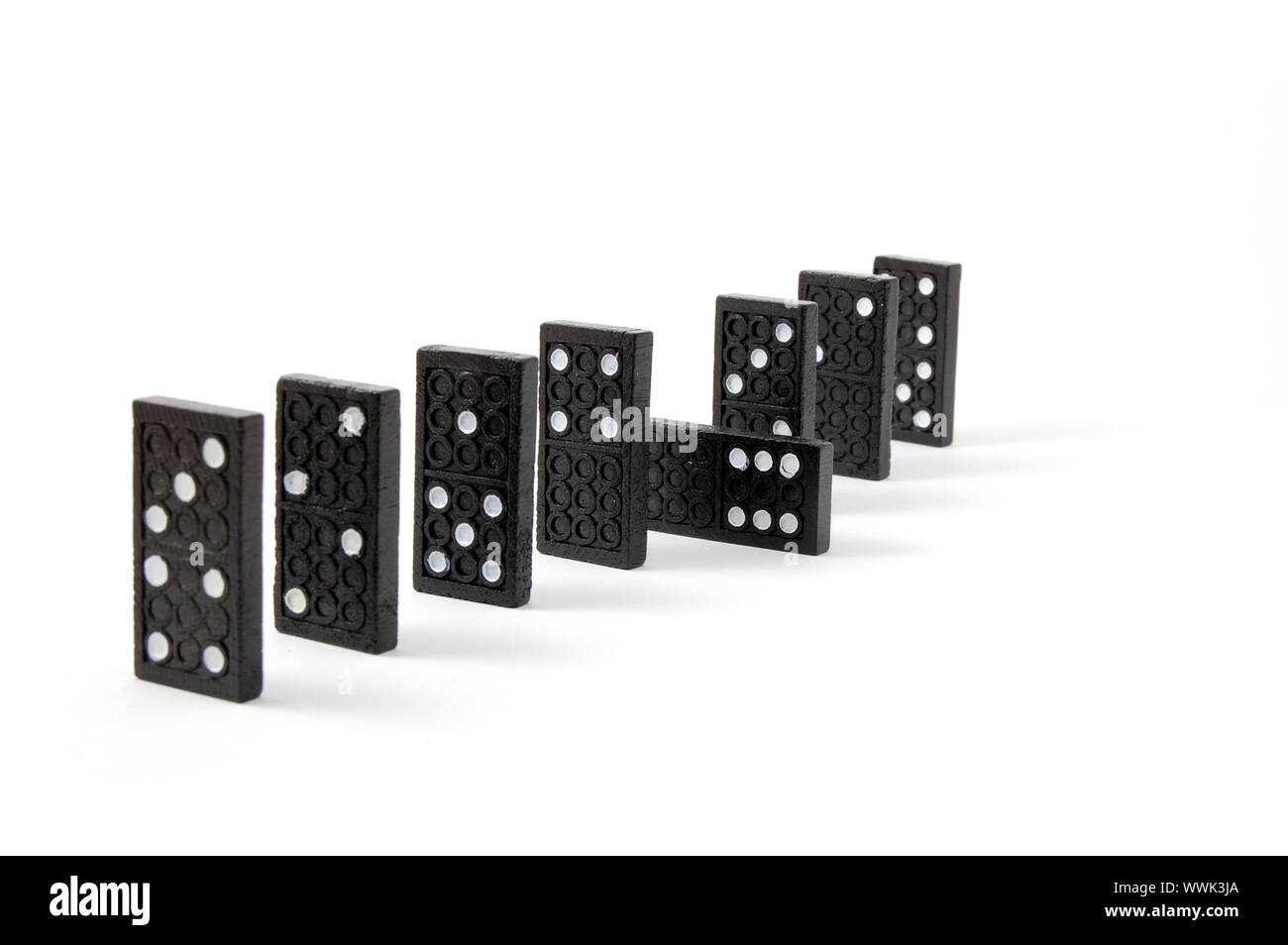 row of dominoes including a special domino stone isolated on white ...