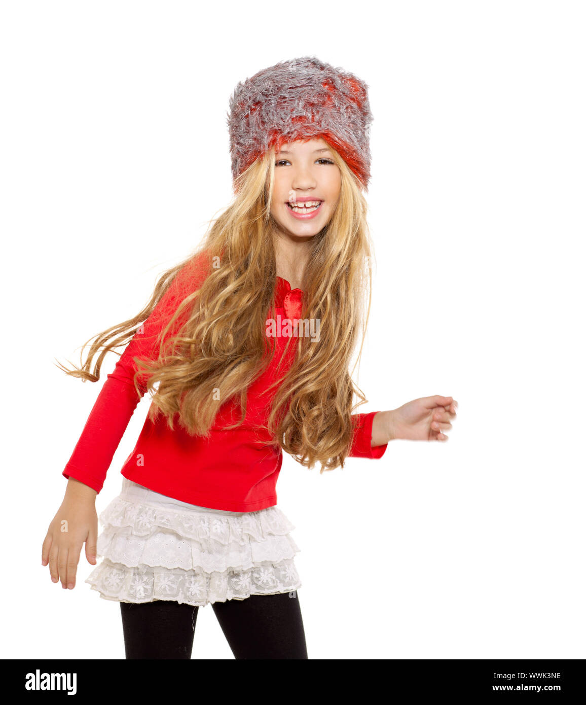 kid girl winter dancing with red shirt and fur hat on white background ...