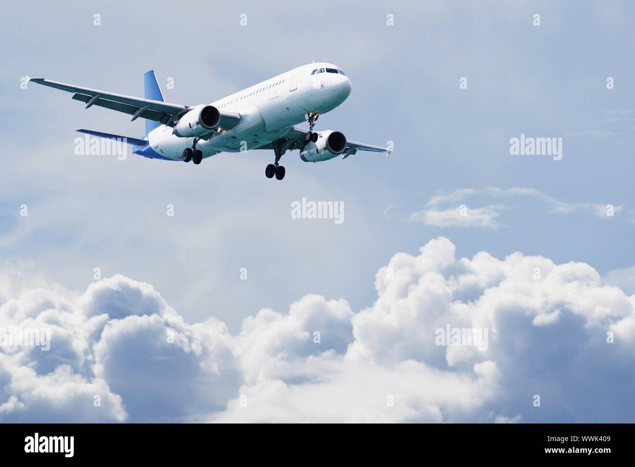 Passenger airliner flying over the clouds Stock Photo - Alamy