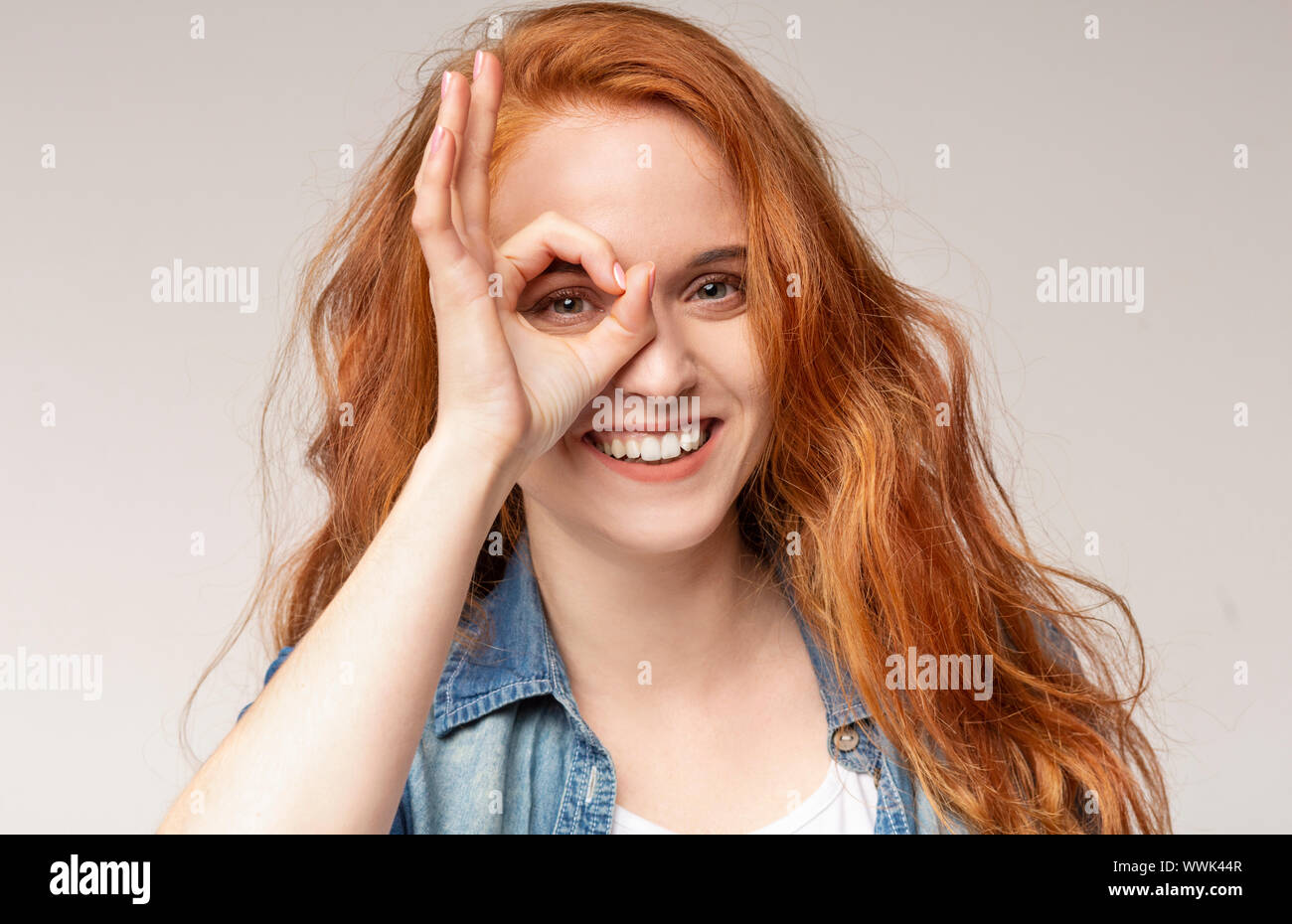 Playful Redhead Girl Showing Ok Sign Gesturing With Fingers Stock
