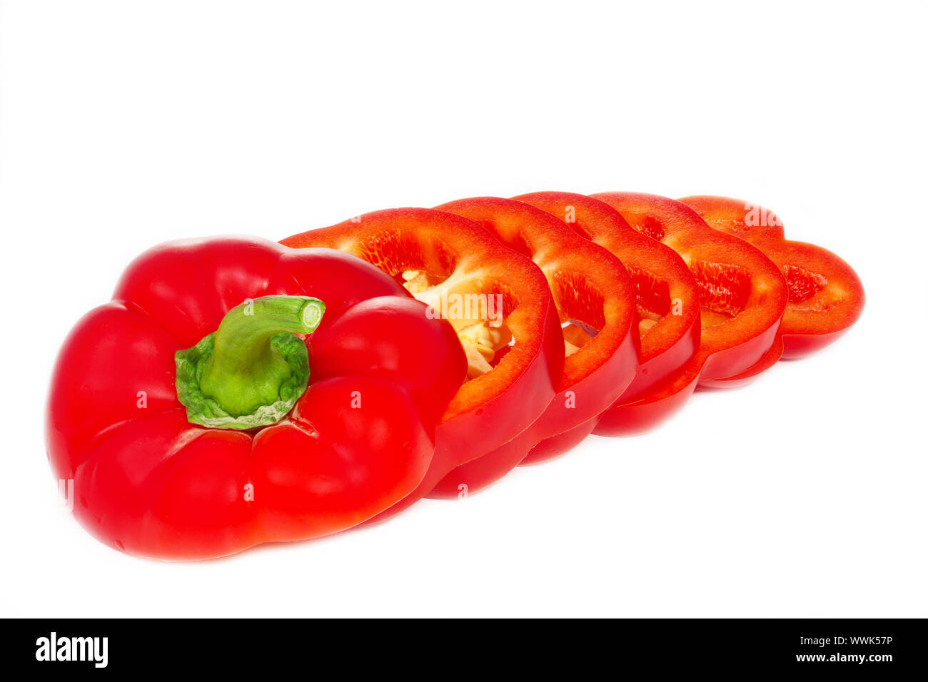 Red peppers cut into rings on a white background Stock Photo - Alamy