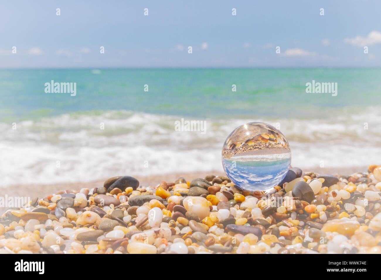 Glass round ball on the beach reflects the sea in summer Stock Photo ...