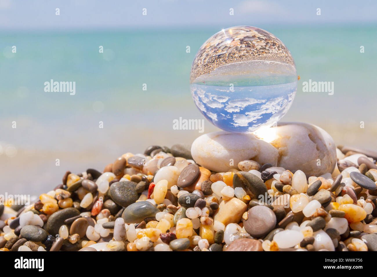 Glass round ball on the beach reflects the sea in summer Stock Photo ...
