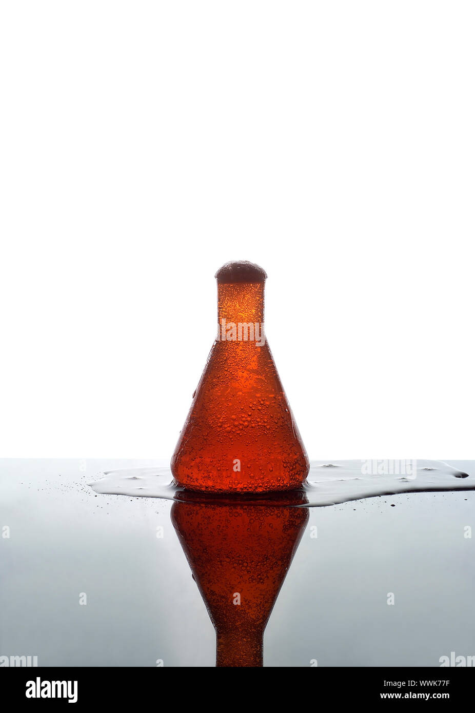 Laboratory Glass with orange liquid Stock Photo - Alamy