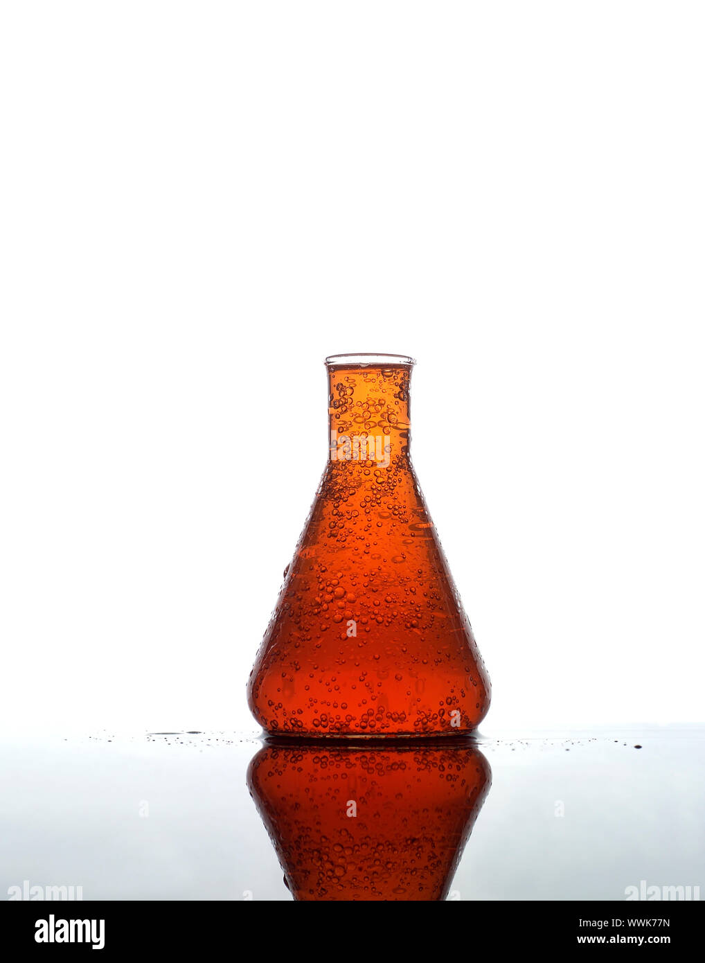Laboratory Glass with orange liquid Stock Photo - Alamy