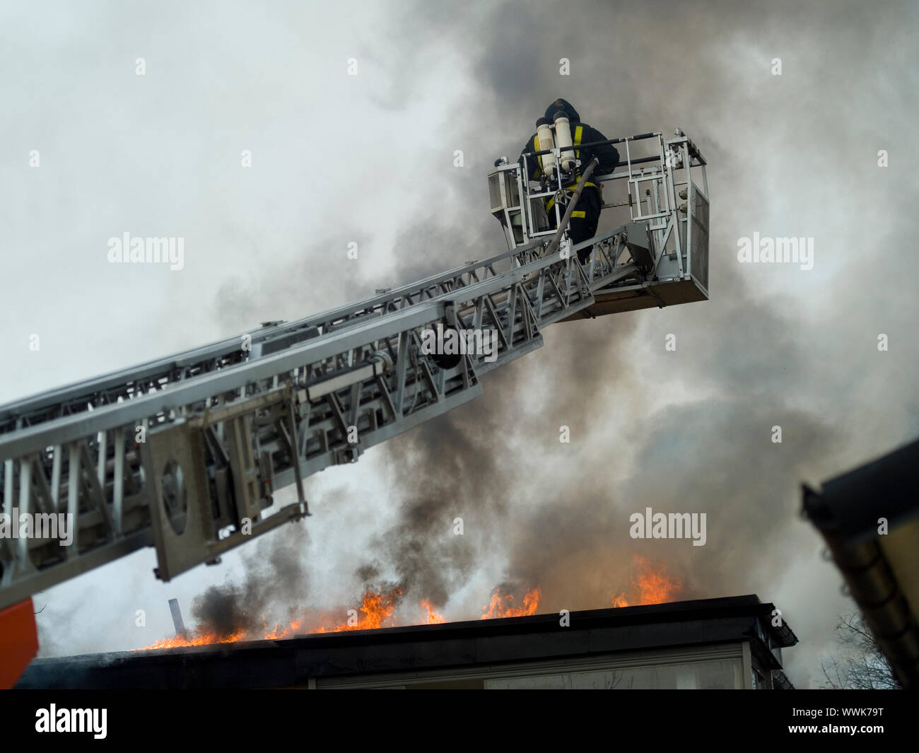 Fireman working on top of a ladder Stock Photo - Alamy