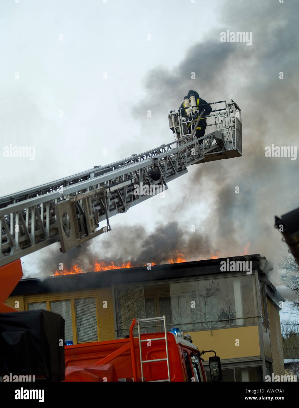 Fireman working on top of a ladder Stock Photo - Alamy