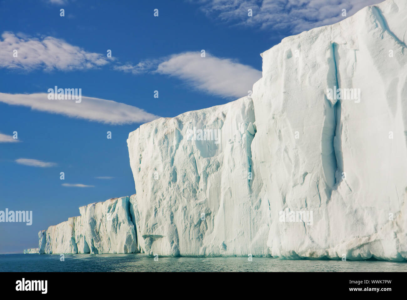 Sun shining on glacial cliff side. Horizontally framed shot Stock Photo ...